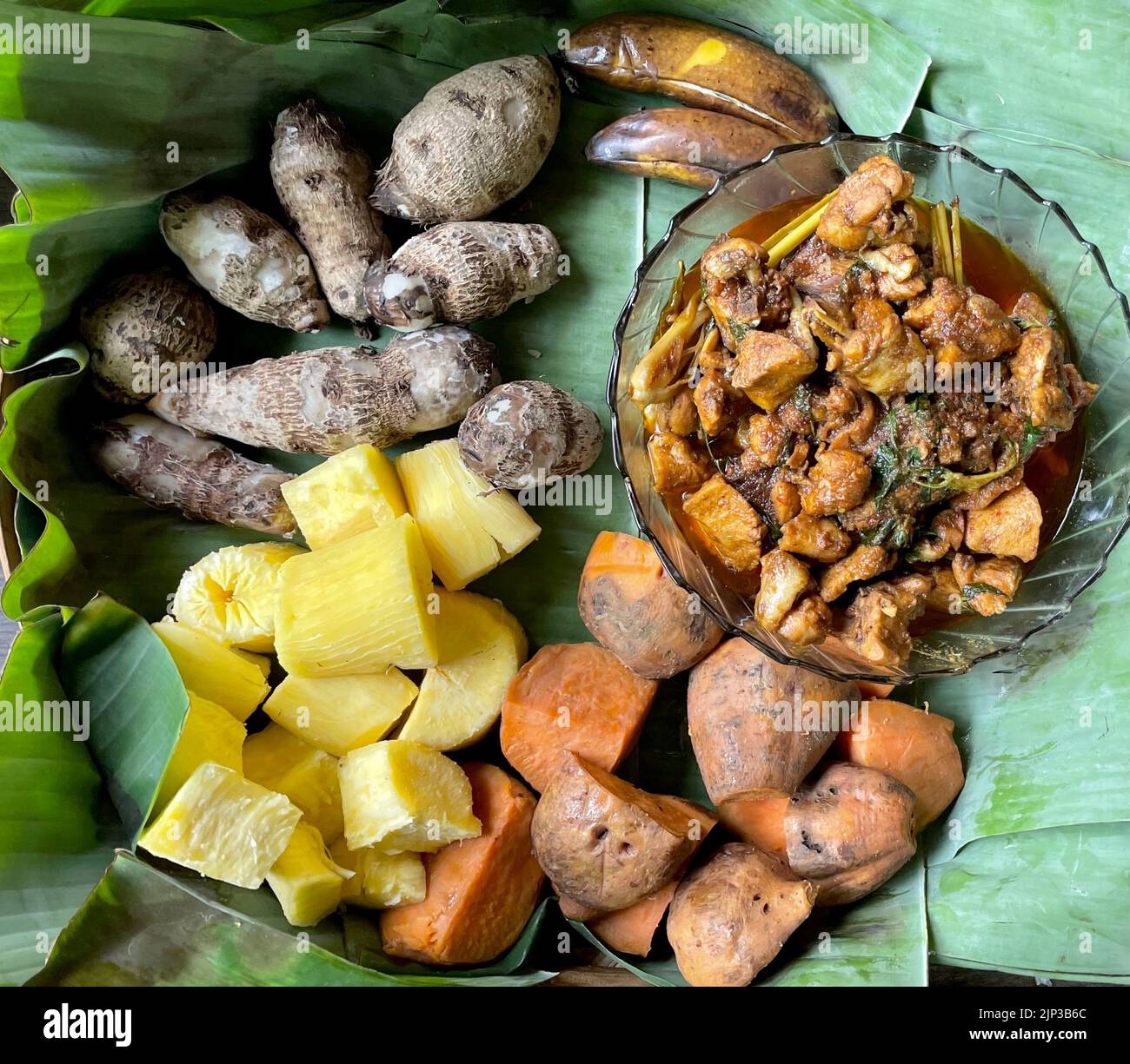 A top view of Javanese traditional stew with cassava, banana, chicken ...