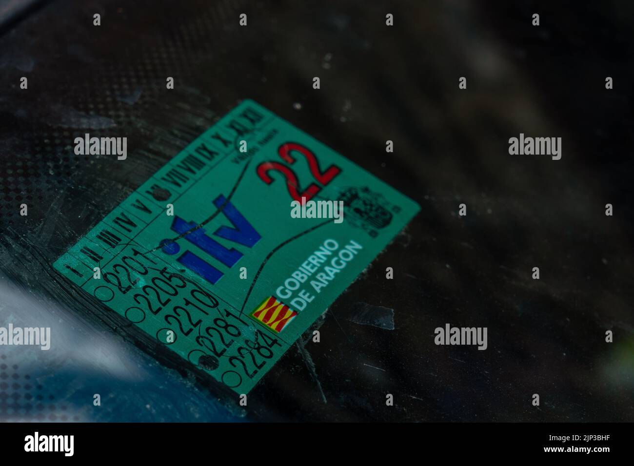 A closeup shot of a vehicle technical inspection sticker in a blue ...