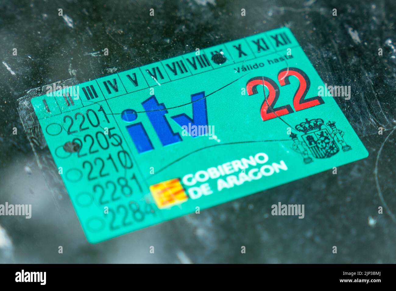 A closeup shot of a vehicle technical inspection sticker in a blue ...