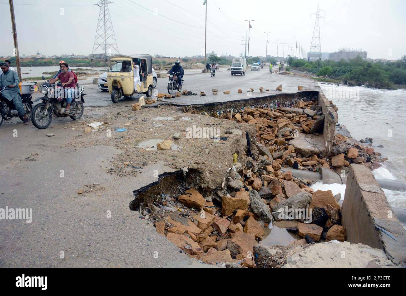 View of destruction at Korangi Crossing road due to stagnant rainwater ...