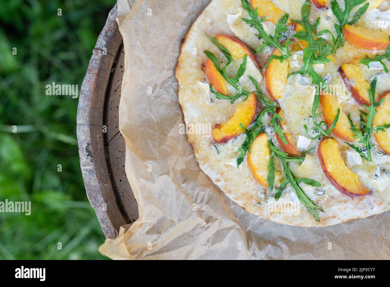 Very tasty and interesting pizza with peach and dor blue with arugula ...