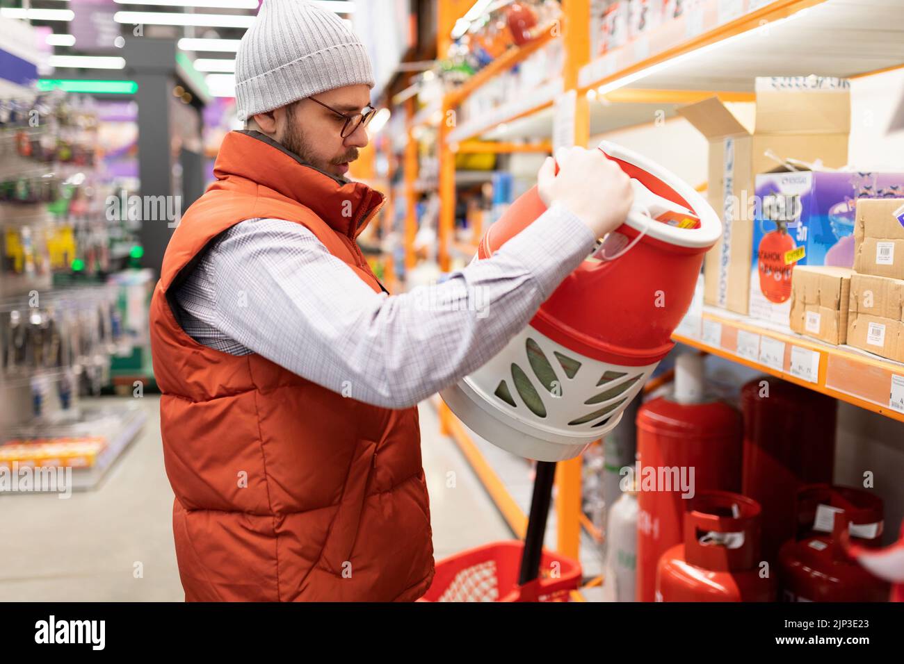 the buyer in the store chooses a gas cylinder for propane Stock Photo ...