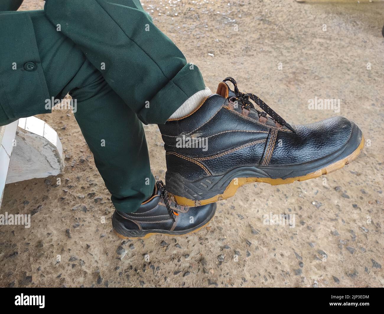 A sit on the feet wearing safety shoes, step on foot photo Stock Photo ...