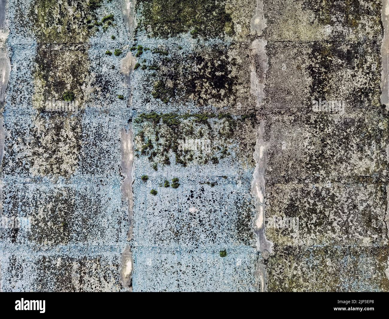 Dirty old eroded cracked plaster cement block fence. Concrete block ...