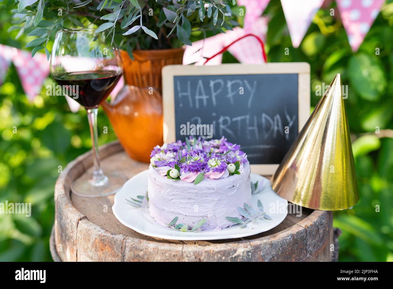 A very beautiful bento cake with purple, veri peri, matthiola flowers ...