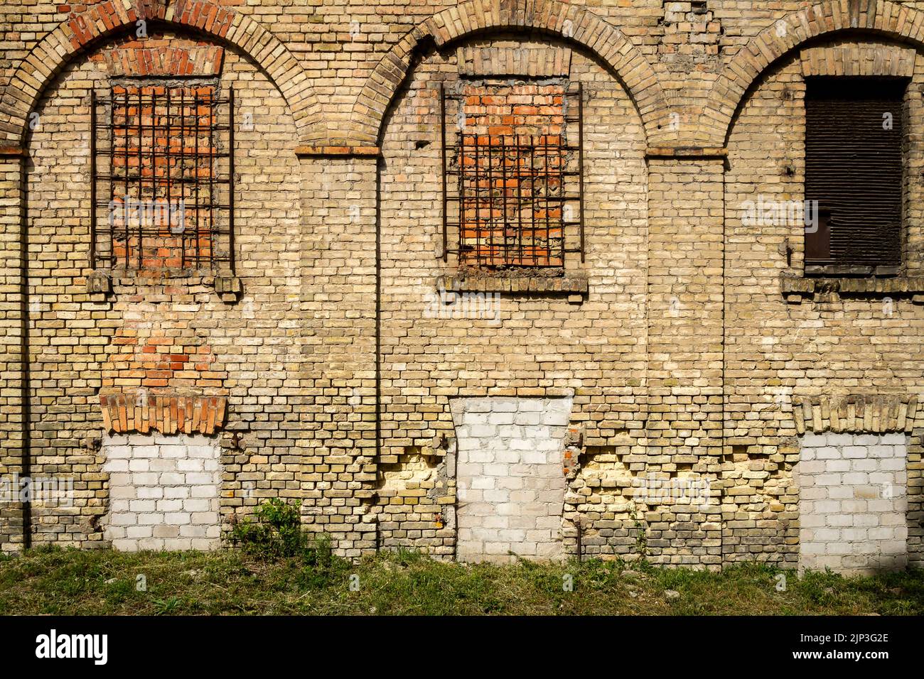 Old abandoned wall with bricked up windows. Architecture detail background. Forgotten building ...