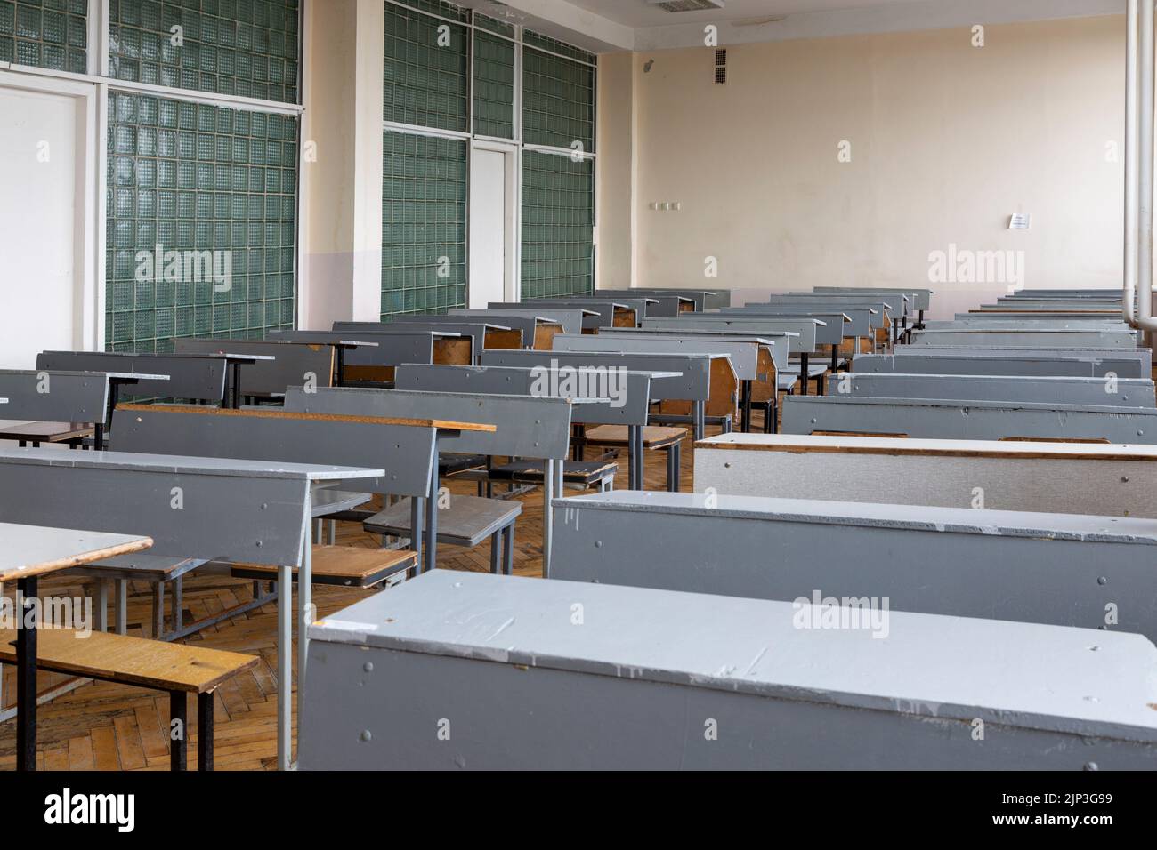 A fragment of the interior of the classroom with desks in an ...