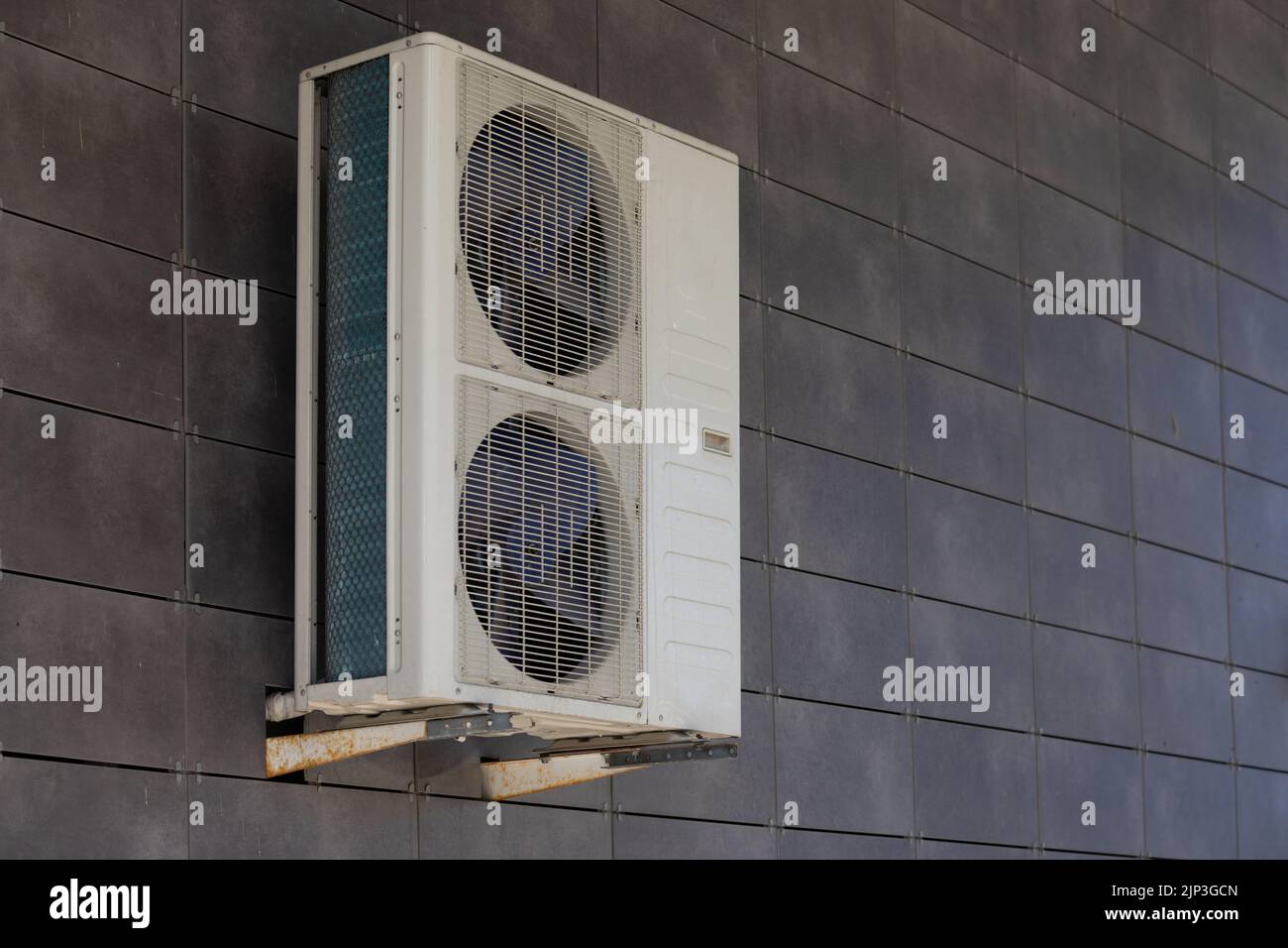 outdoor unit of a domestic air conditioner with a fan outside the ...