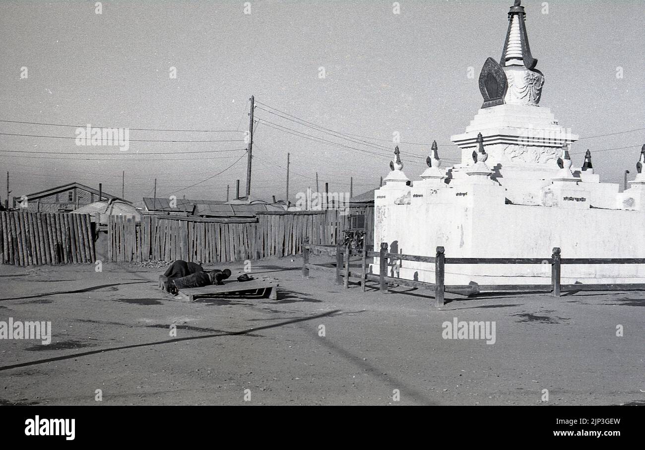 1960s, historical, outside, in front of a Buddhist stupa, a scared ...