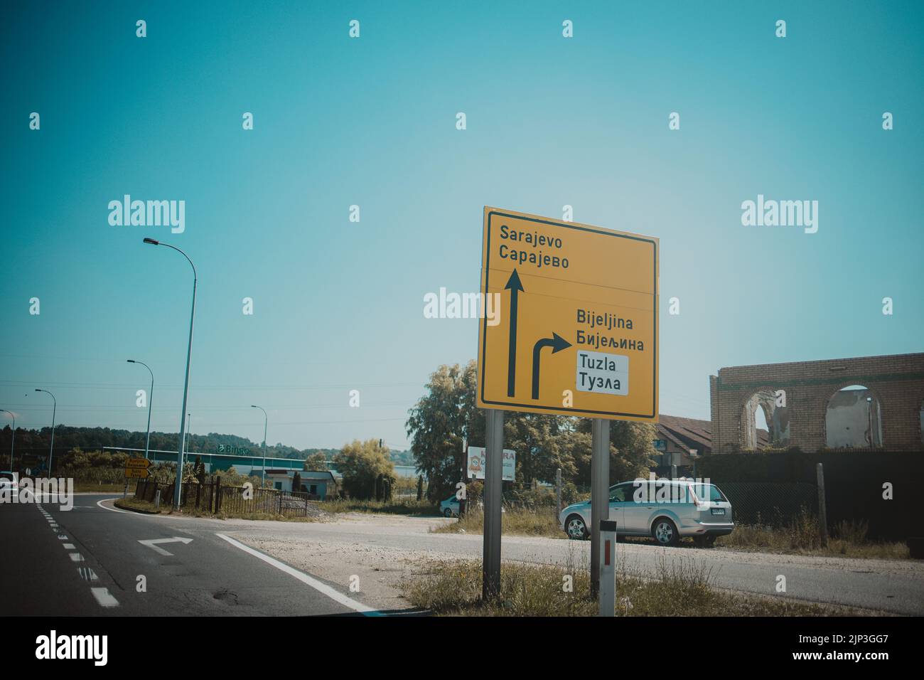A yellow direction sign leading to Sarajevo and Bijeljina Stock Photo ...