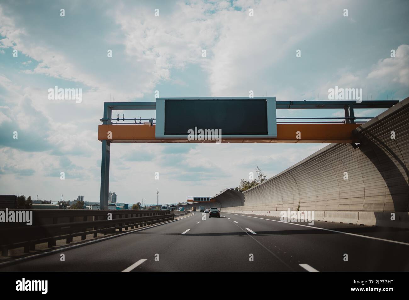 A modern asphalted highway under the cloudy sky Stock Photo - Alamy