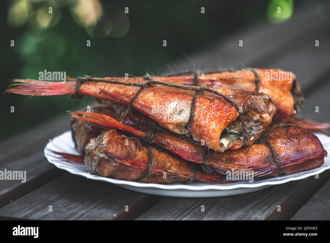 smoked fish sea bass on the table. homemade smoking Stock Photo - Alamy