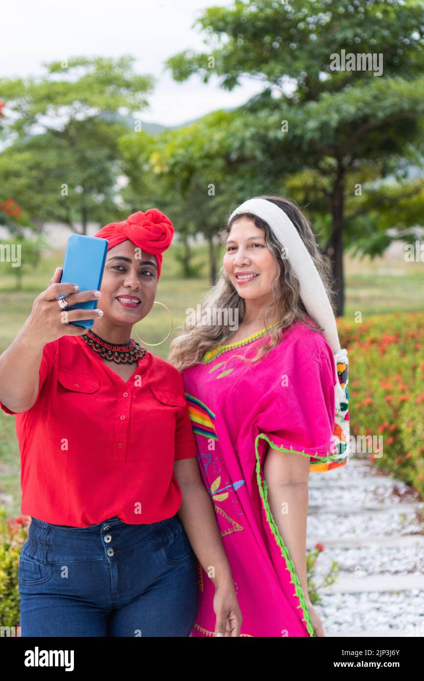 Two indigenou women taking a selfie in a park Stock Photo - Alamy