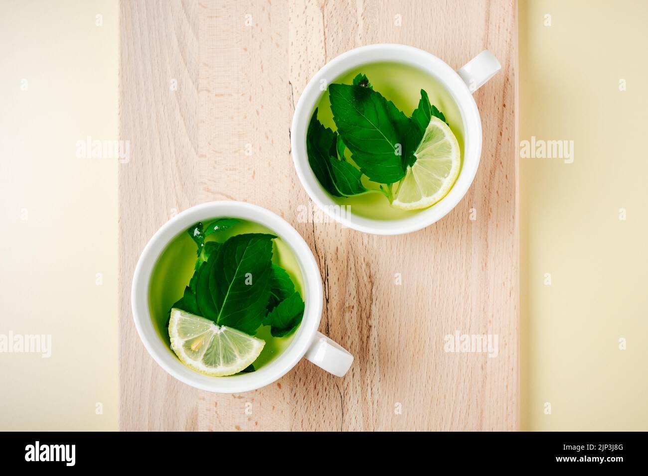 Two cups of hot mint tea with lemon Stock Photo - Alamy