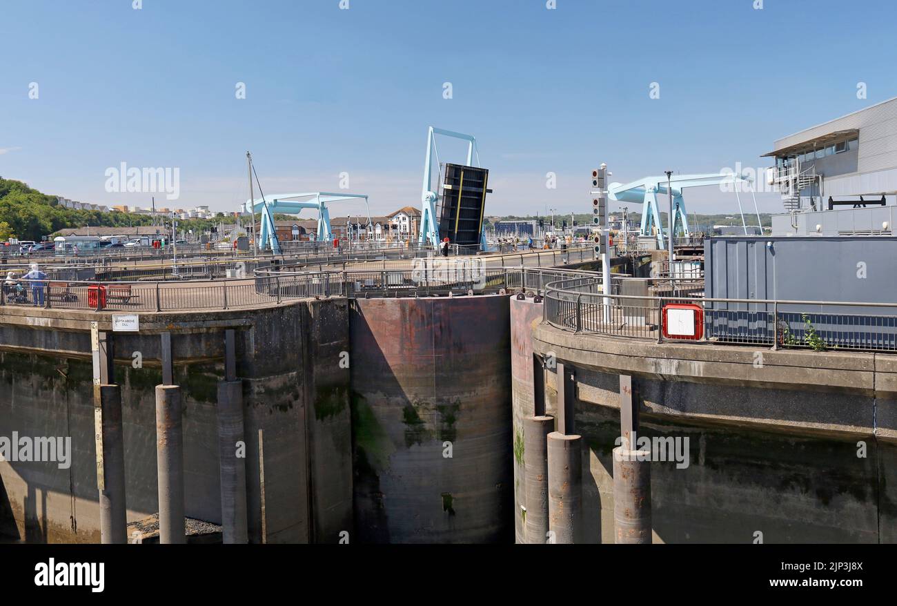 Road bridge lifting to allow boats in and out of barrage lock gates ...