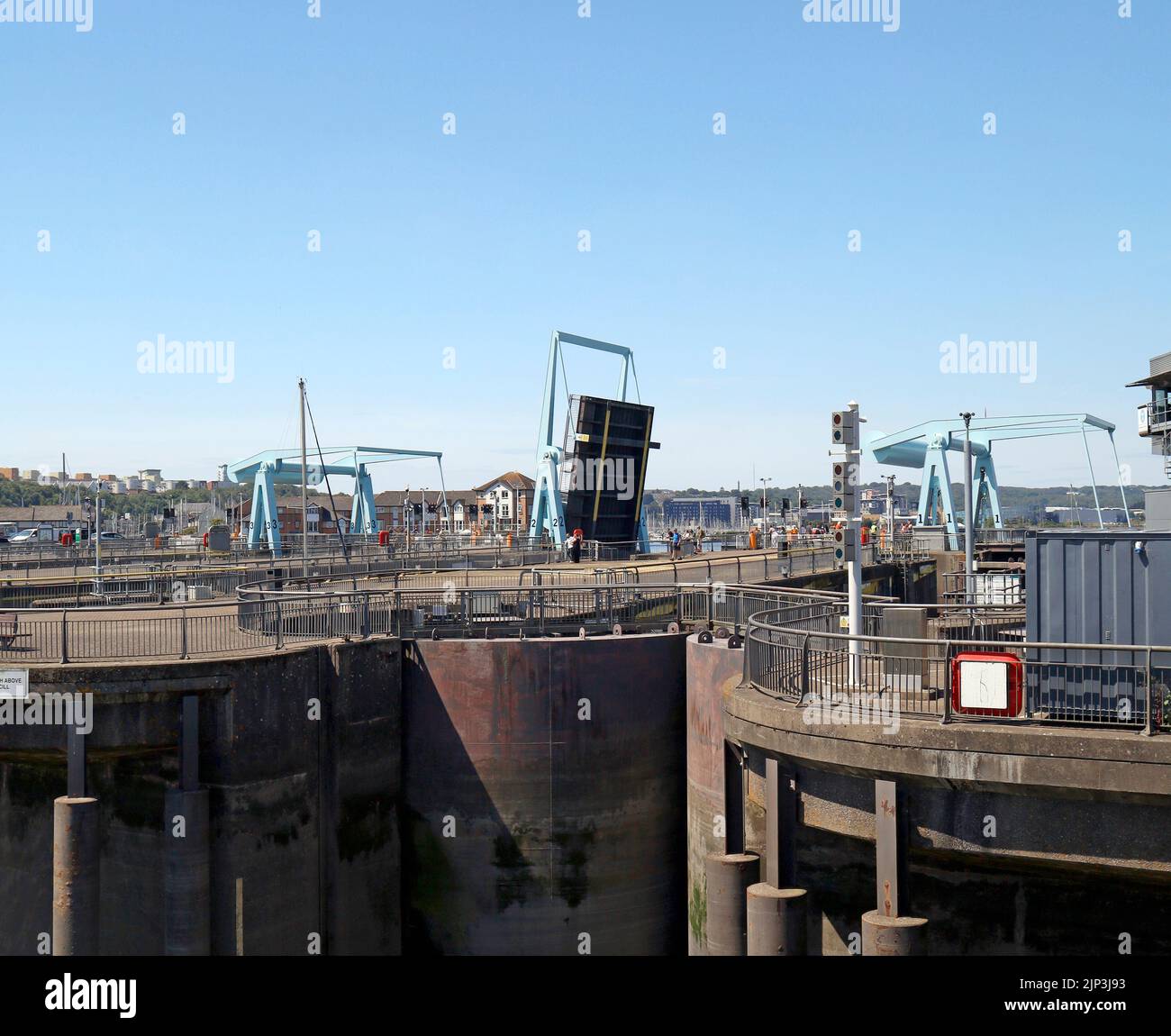 Road bridge lifting to allow boats in and out of barrage lock gates ...