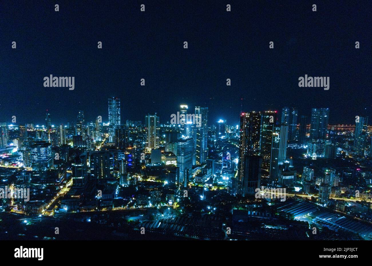 The illuminated high-rise buildings of a city at night Stock Photo - Alamy