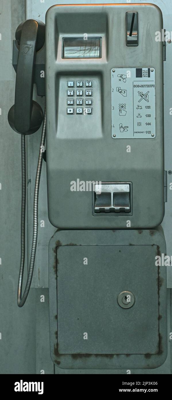 An old telephone in a booth Stock Photo - Alamy