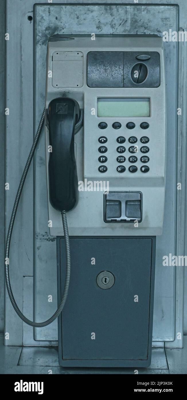 An old telephone in a booth Stock Photo - Alamy