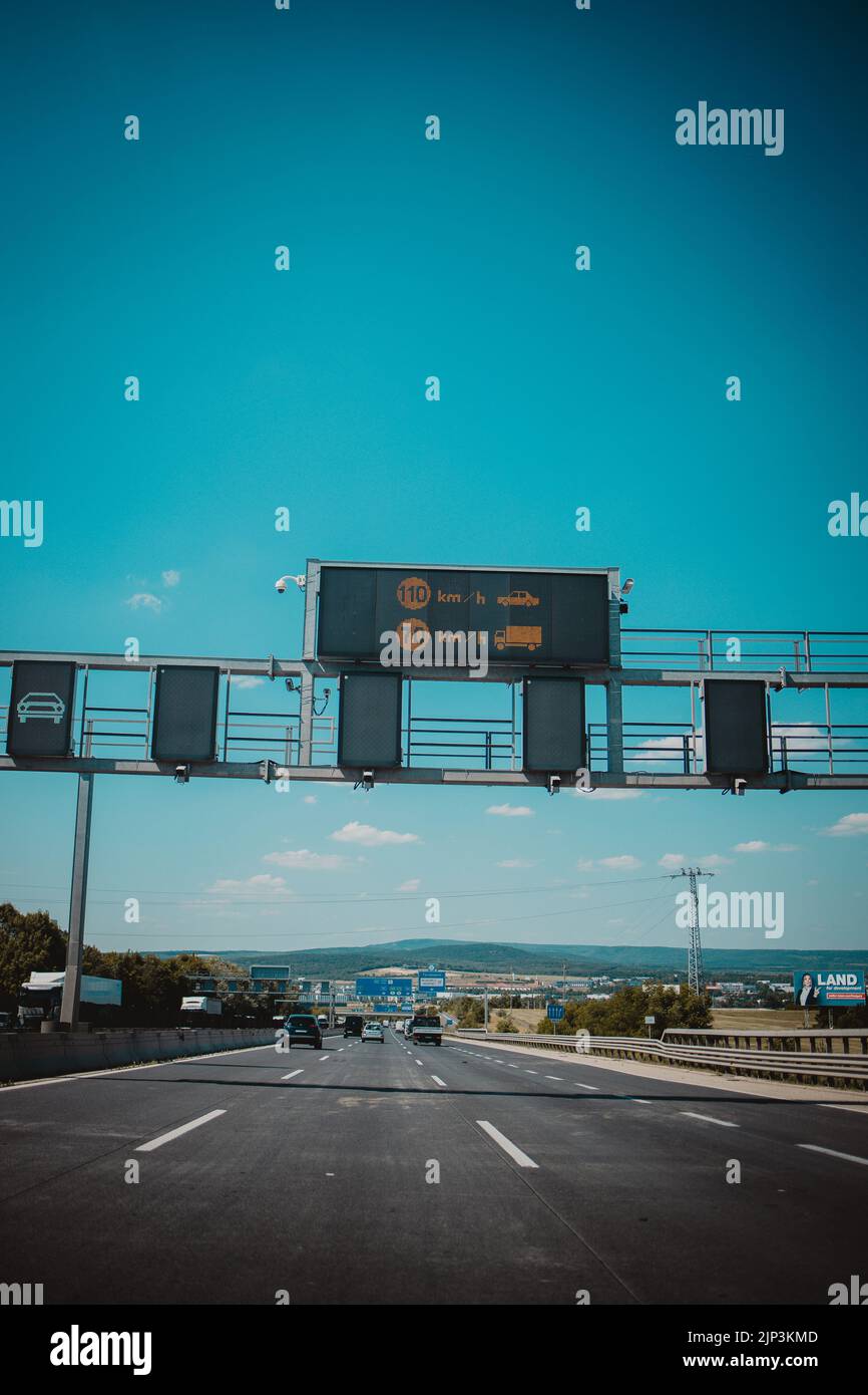 A vertical shot of a highway traffic sign in Vienna, Austria with blue ...