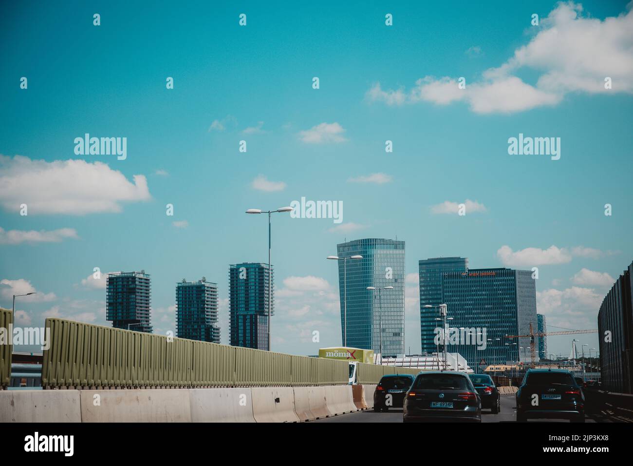 A highway traffic in Vienna, Austria with blue cloudy sky buildings in ...
