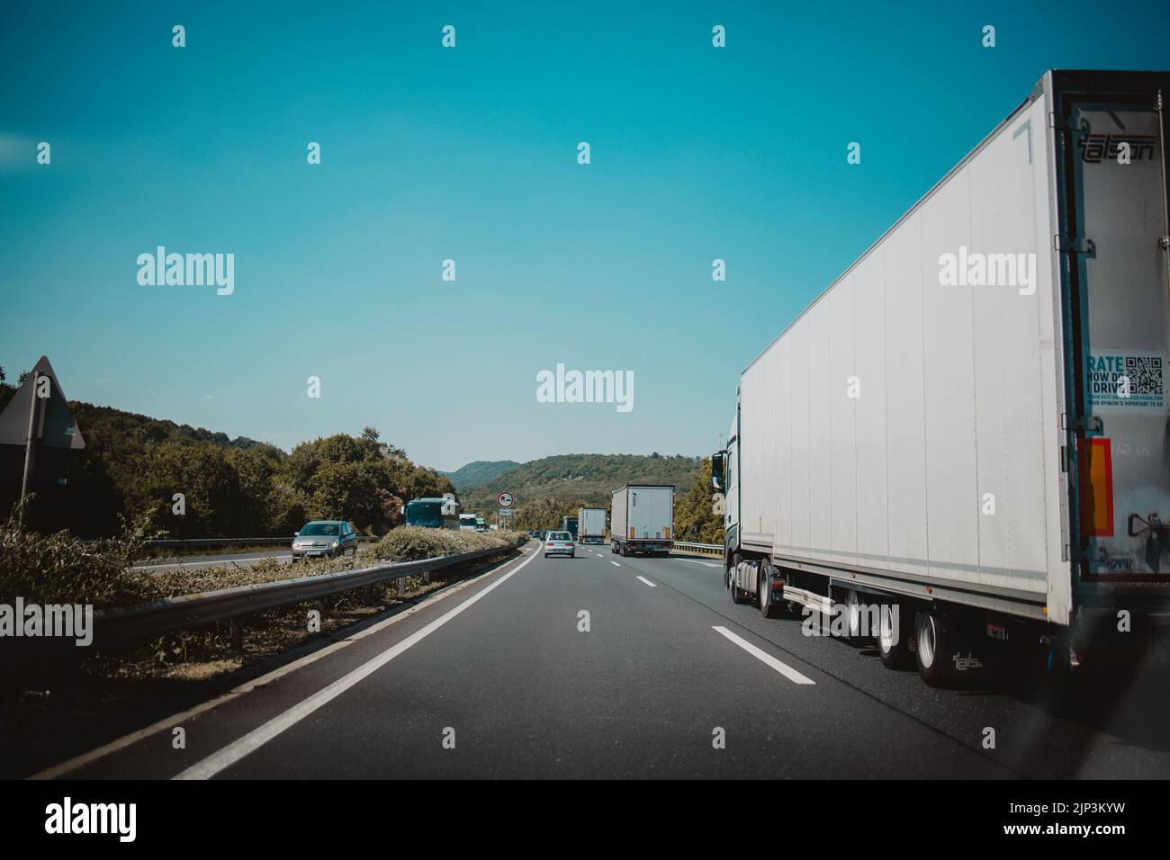 A highway traffic in Vienna, Austria with blue sky background, trees ...
