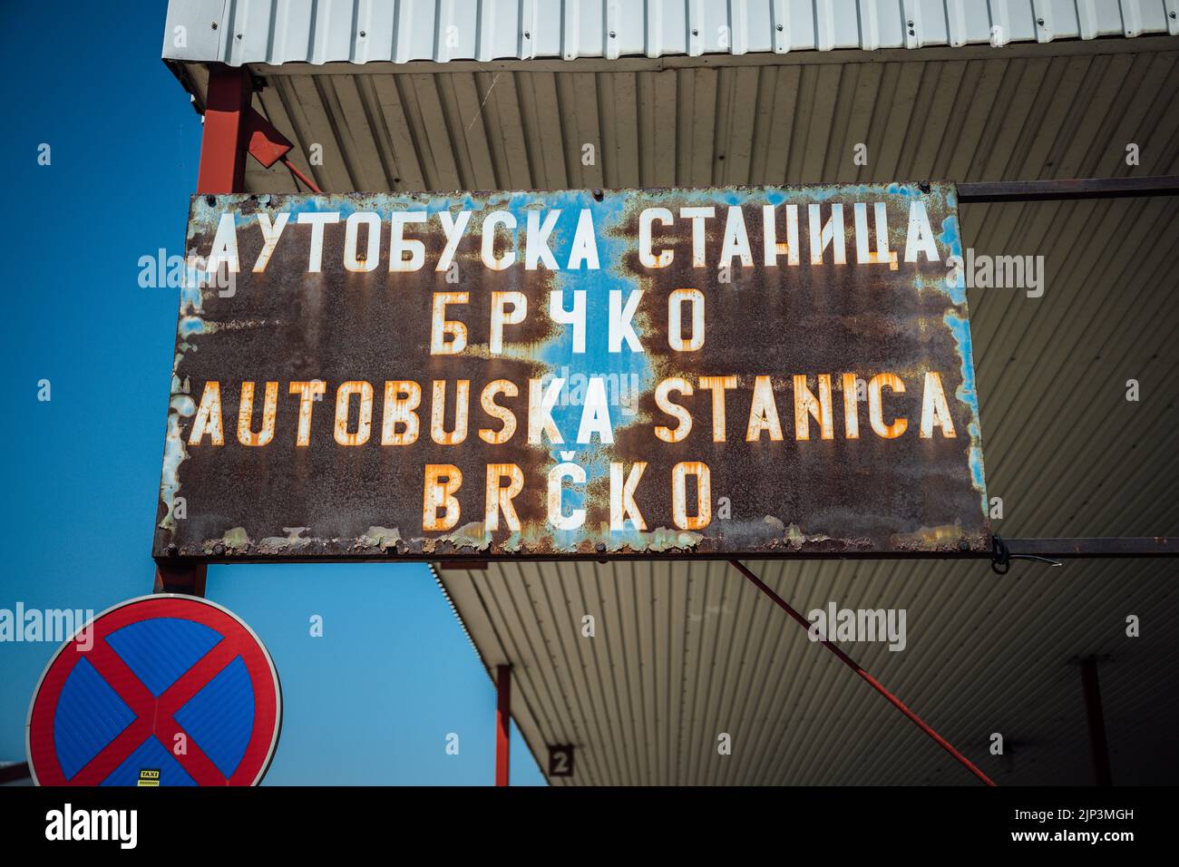 An old and rusty bus station sign indicating the bus stop in Brcko ...