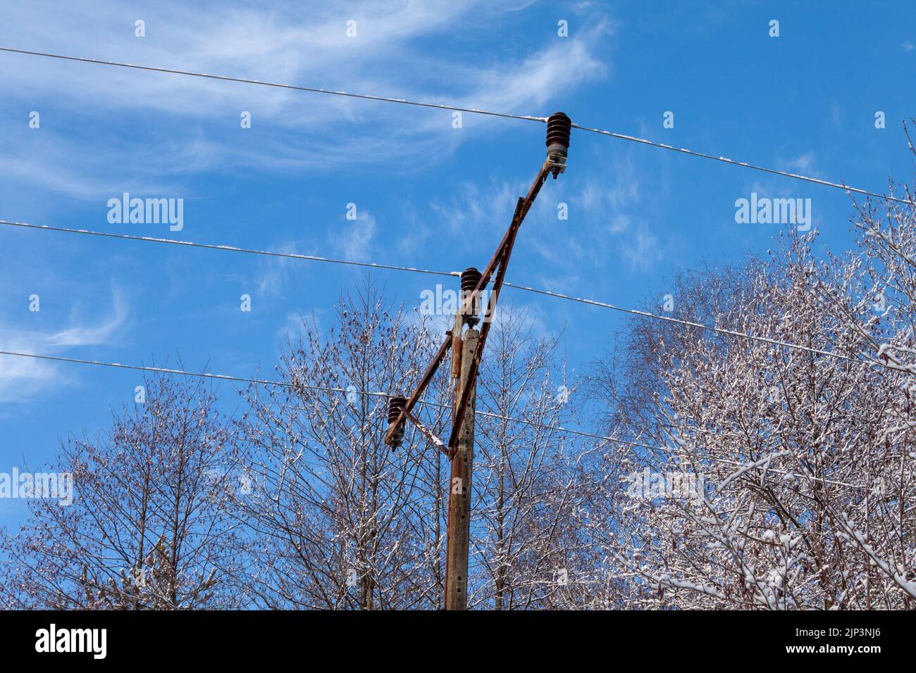 Rusted electric pole during winter with trees in the background Stock ...