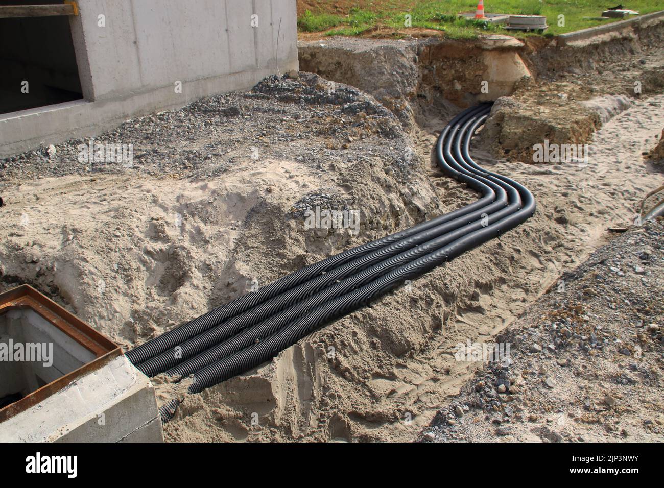 Empty conduits for cables lie in a trench Stock Photo - Alamy