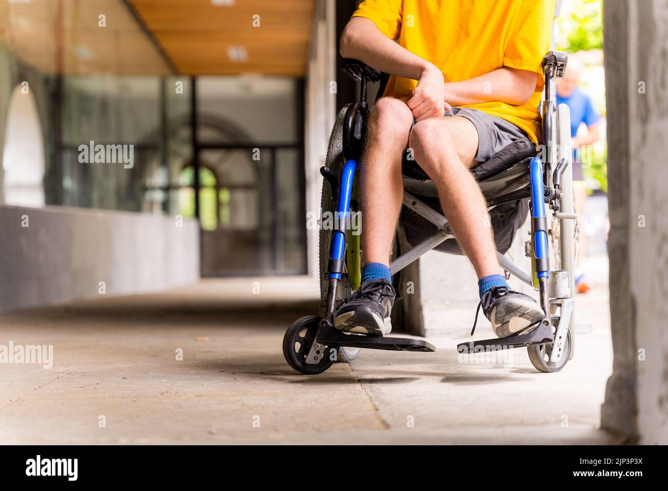 A disabled person in a wheelchair walking through the town square Stock ...