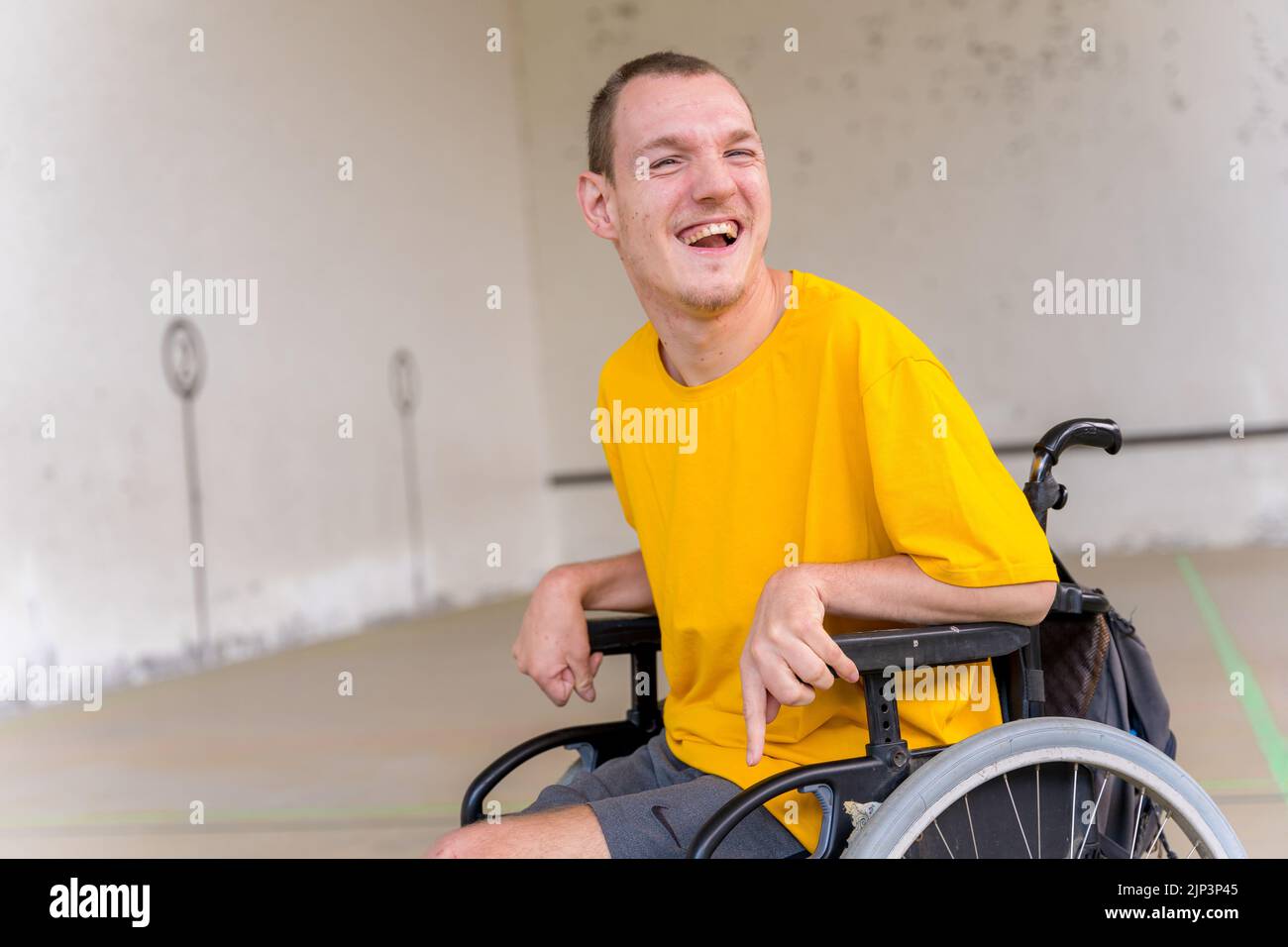 A disabled person in a wheelchair walking through the town square Stock ...