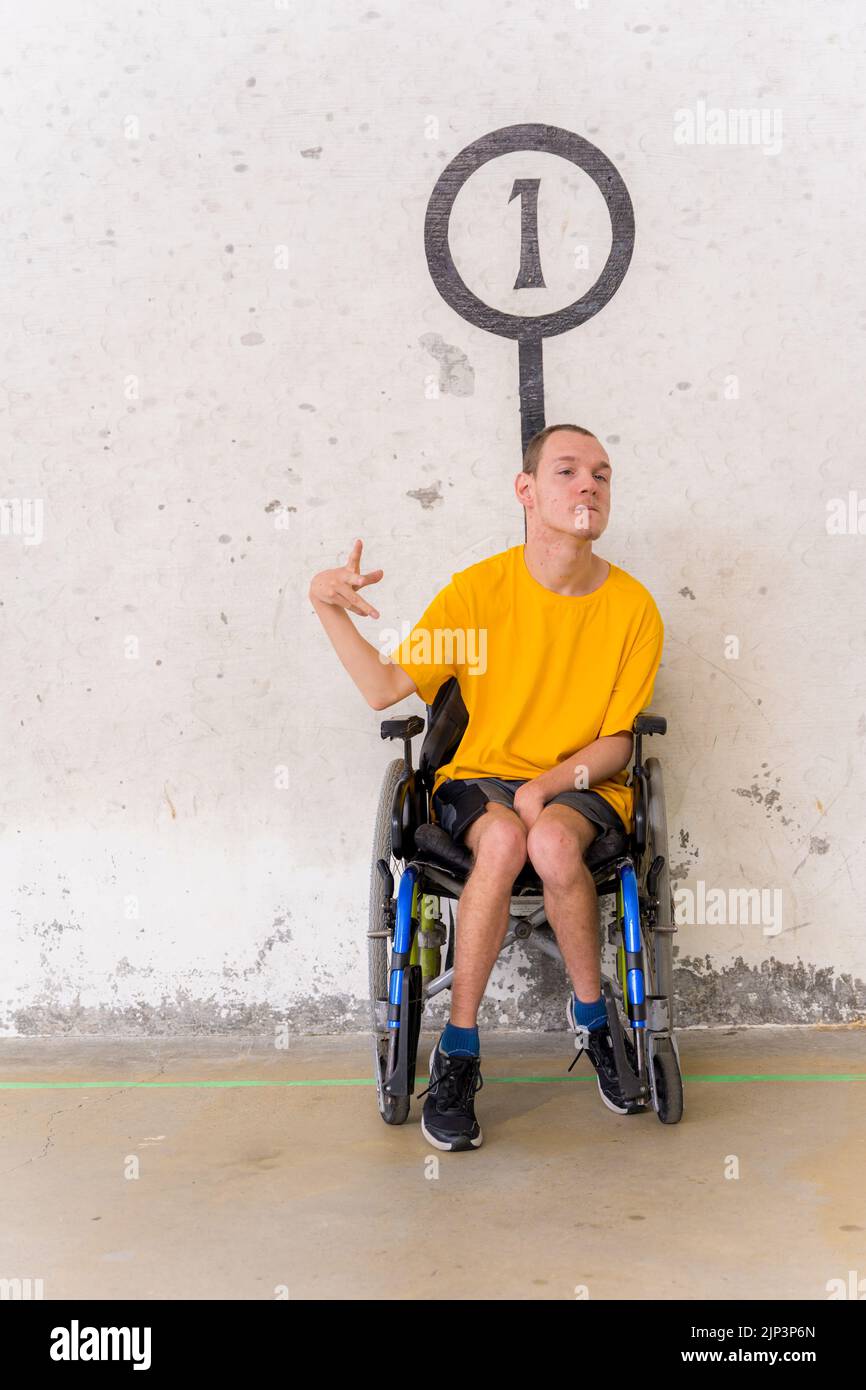 A disabled person in a wheelchair walking through the town square Stock ...