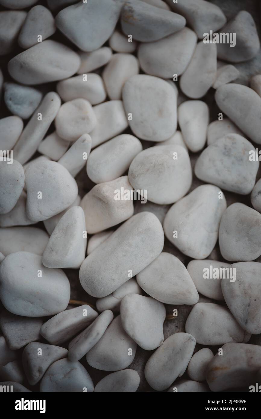 A vertical closeup shot of a heap of gray pebbles Stock Photo - Alamy