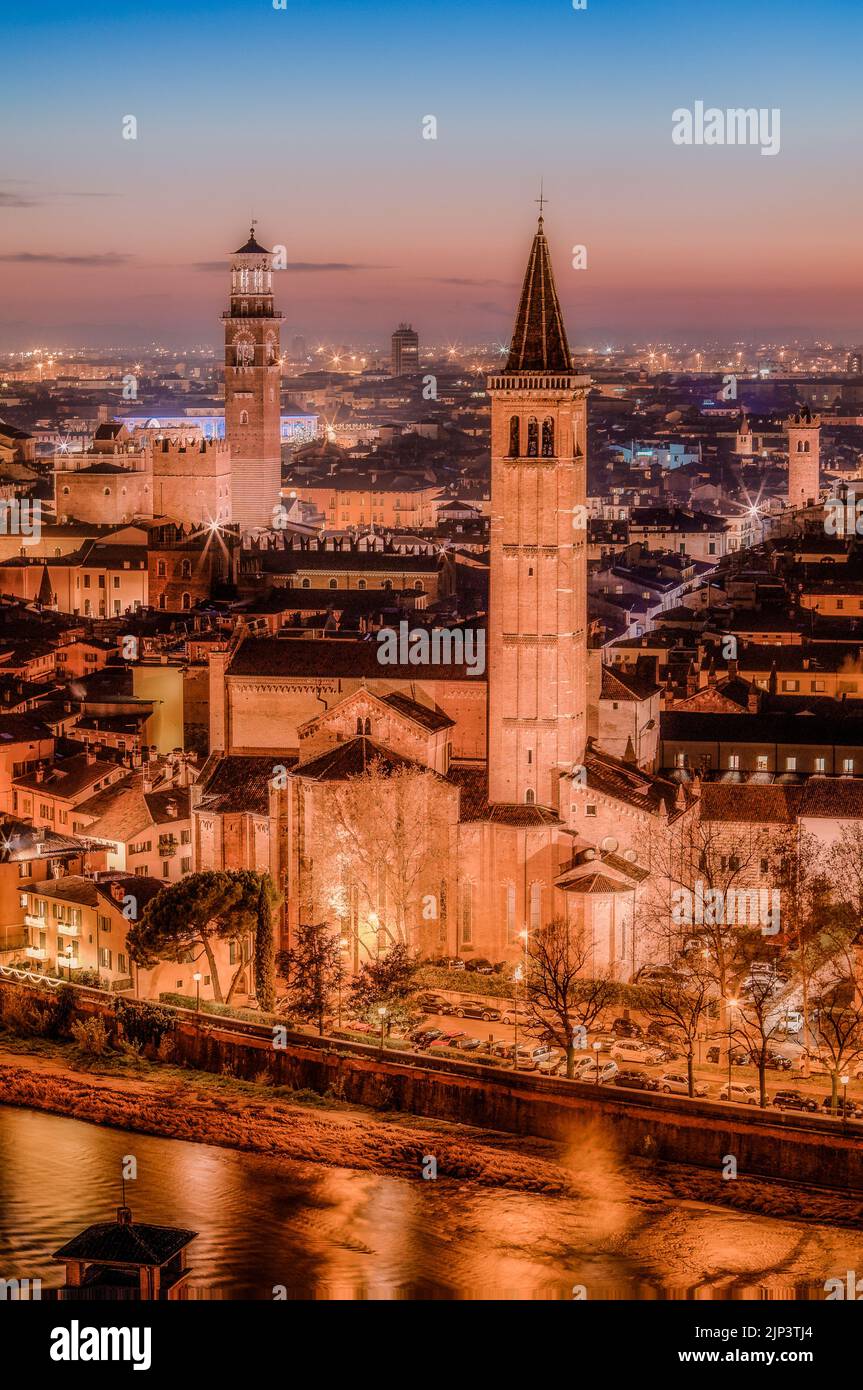 An aerial vertical view of illuminated Verona during sunset, Italy ...