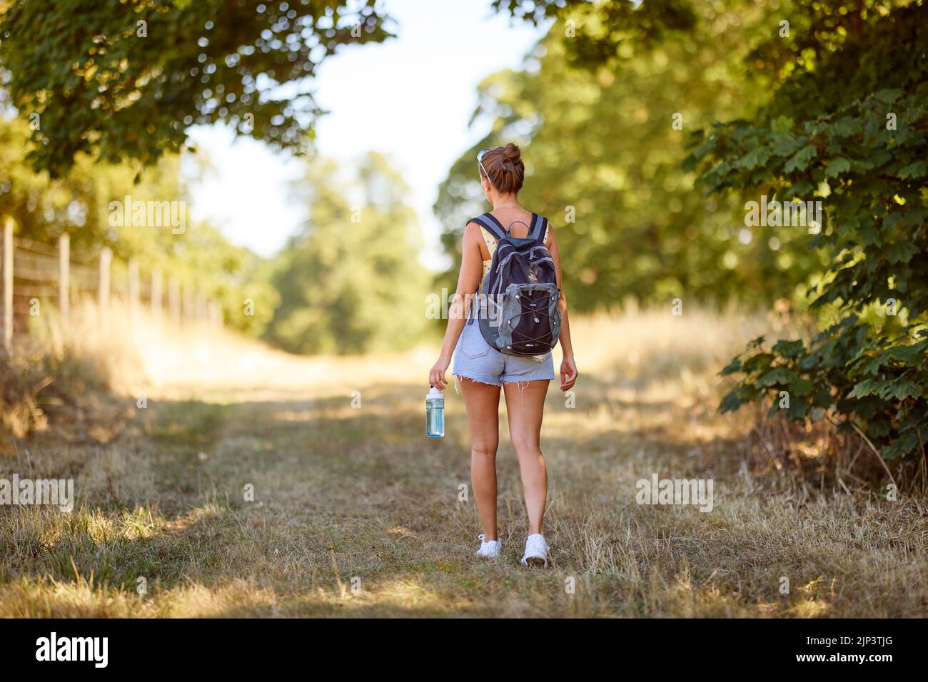 Woman walking outdoors in the countryside Stock Photo - Alamy