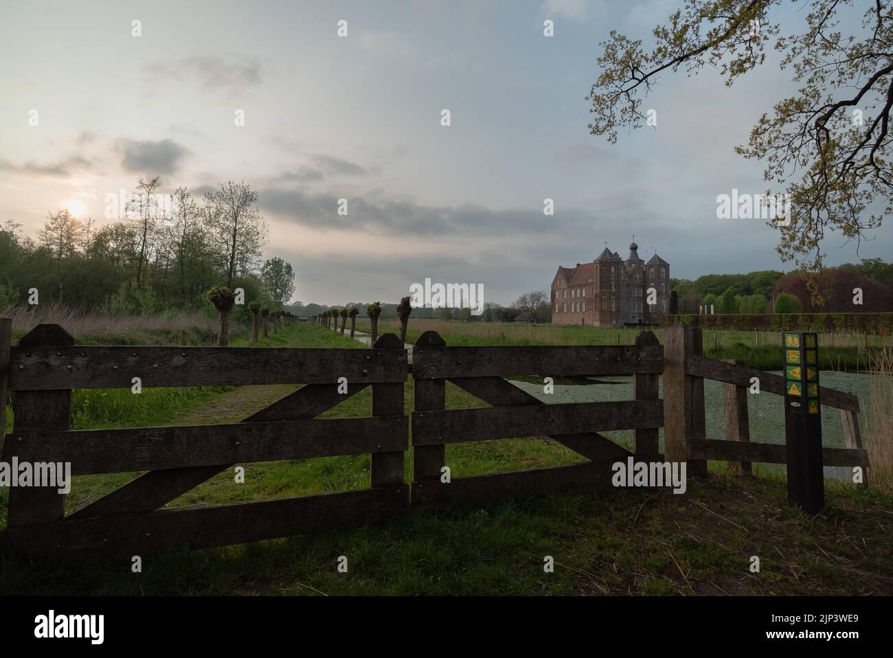 A lovely view of the Croy Castle with a wooden pasture gate and ...
