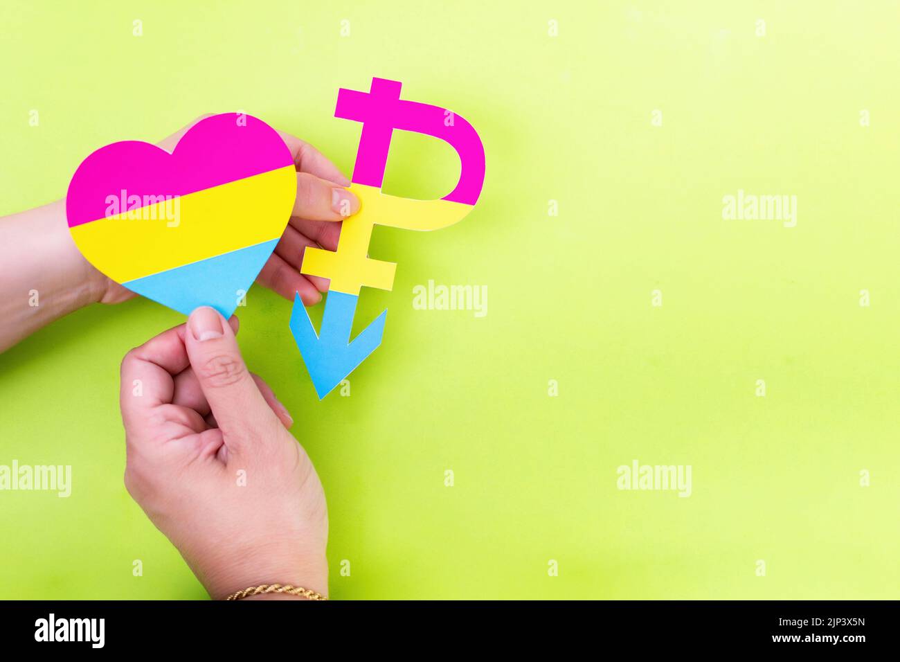 The hands holding the pansexual symbol and flag in the shape of a heart ...