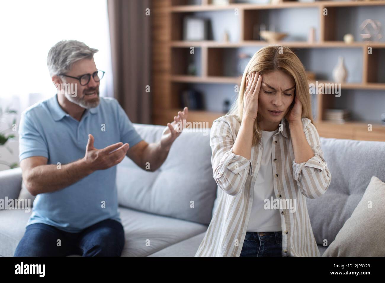 Sad upset angry adult european husband yells at unhappy wife, covers ...