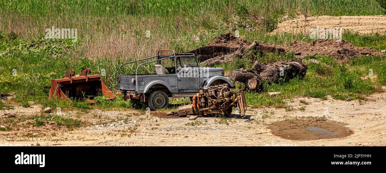 car cemetery with an engine and a car Stock Photo - Alamy