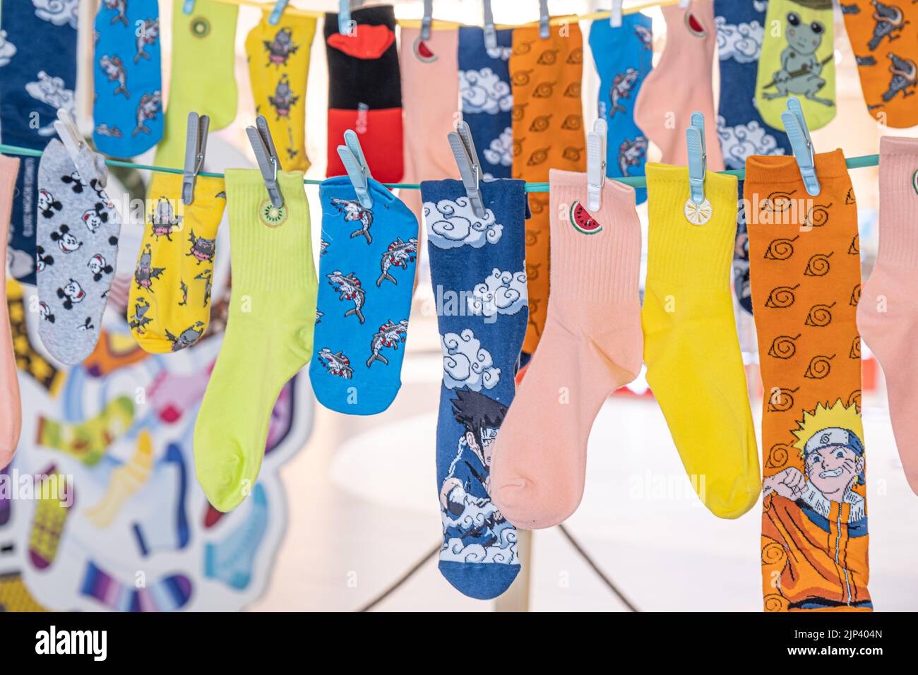 Different Multicolored Socks hanging on the rope Stock Photo - Alamy