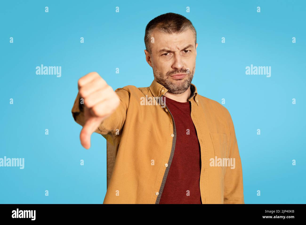 Middle aged businessman thumbs down hi-res stock photography and images ...