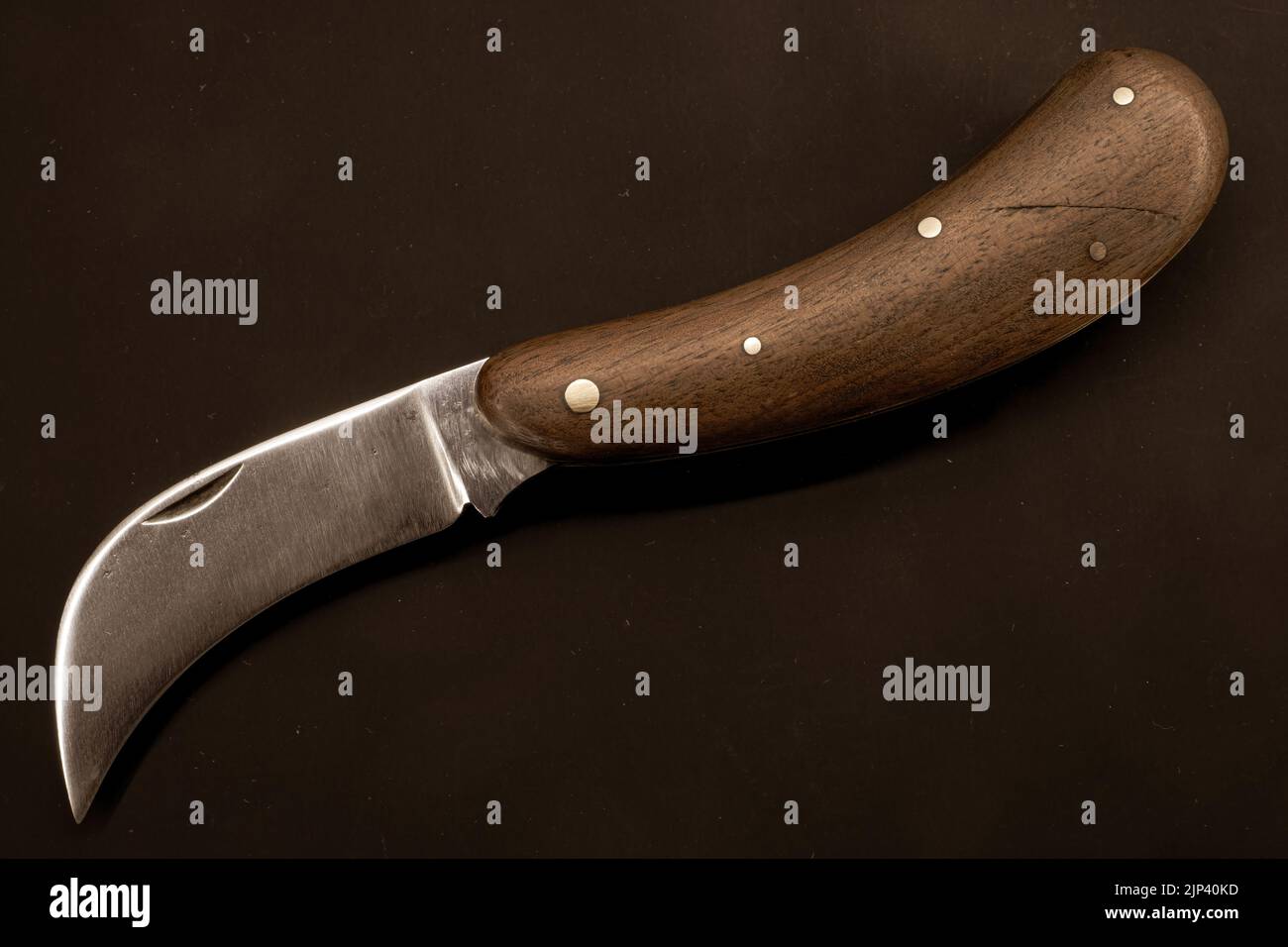 folding pruning knife with curved long blade on vintage paper ...
