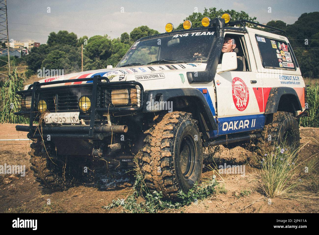 An off road Nissan Patrol Classic car running in the mud Stock Photo ...