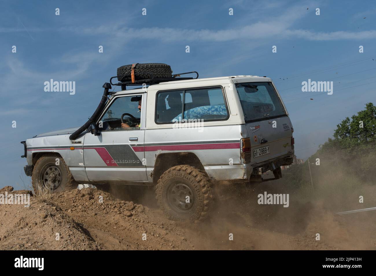 An off road Nissan Patrol Classic car running in the mud Stock Photo ...