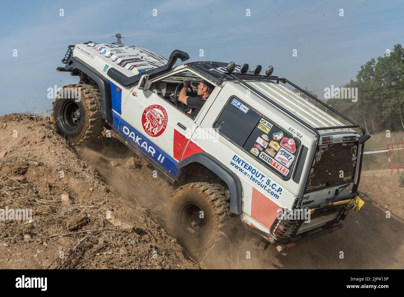 An off road Nissan Patrol Classic car running in the mud Stock Photo ...