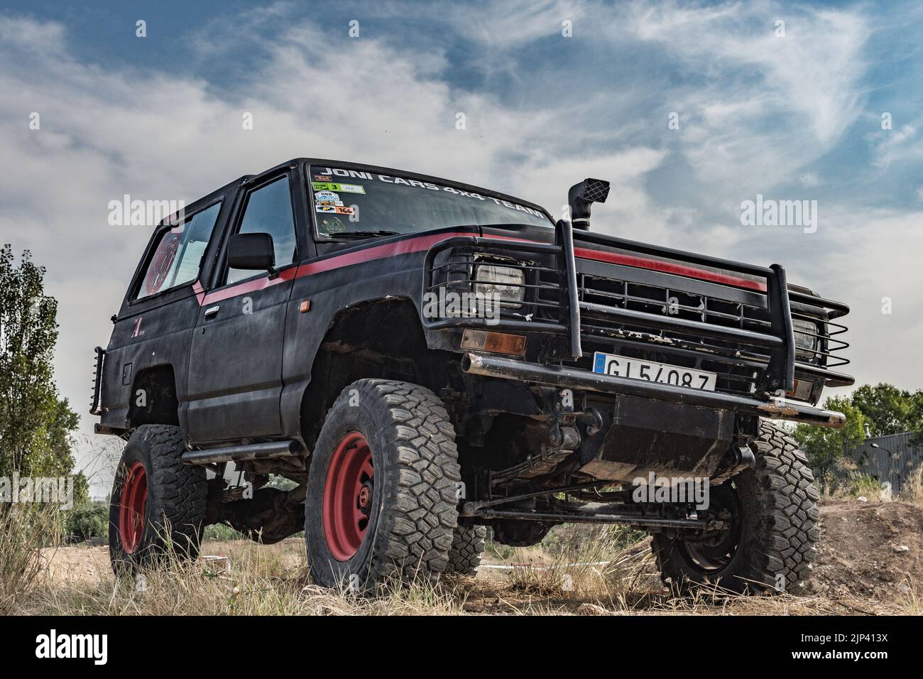 An off road Nissan Patrol Classic car running in the mud Stock Photo ...