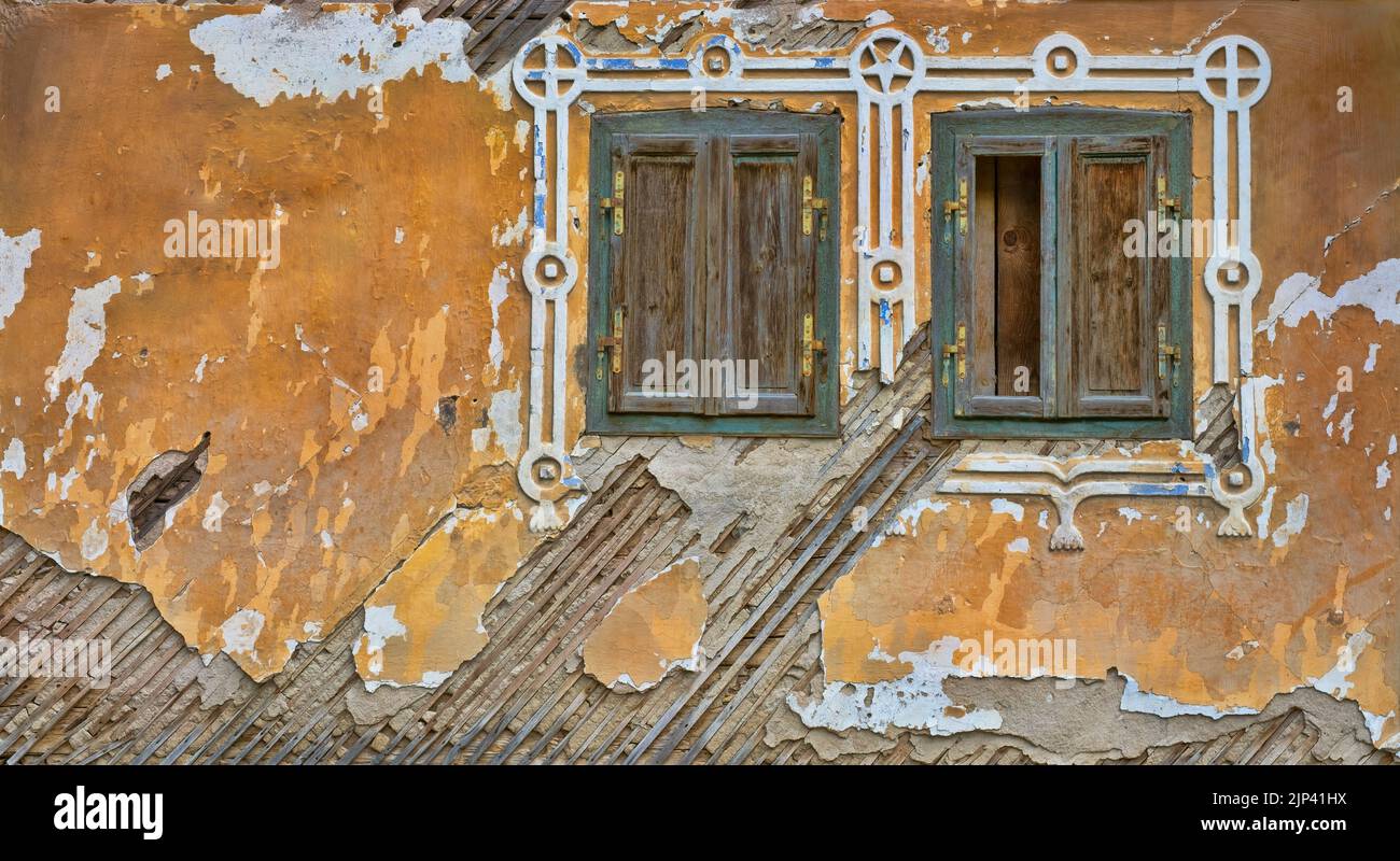 old derelict house with shutters and fallen plaster in Rau Sadului ...