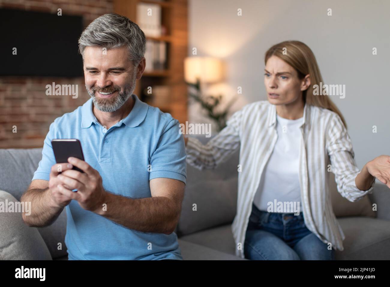 Angry Upset Adult European Wife Yelling At Smiling Husband With