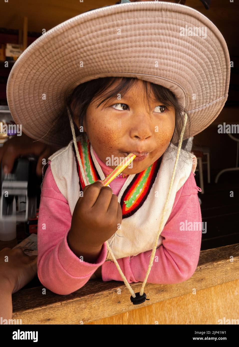 Puno, Peru - October 04, 2021. Portrait of little girl with lollipop ...