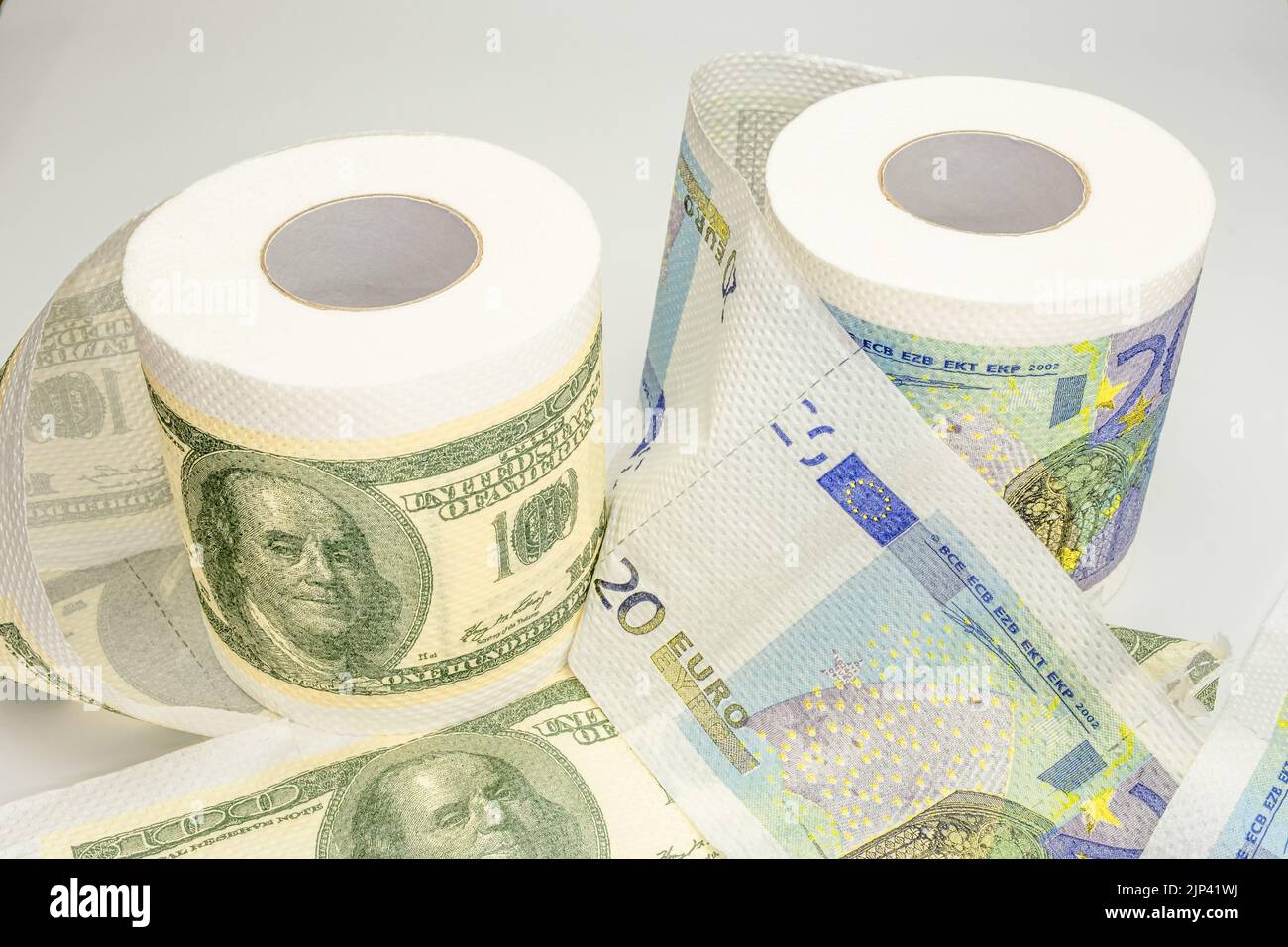 Rolls of bank notes toilet paper on white background Stock Photo - Alamy